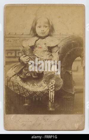 A portrait of 2-year-old Lorrie McDaniel with her dolls. The image ...