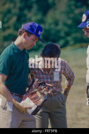 Investigators look over the recovered wreckage of the Chalk's Ocean ...