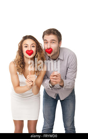 Happy young couple with red hearts on pink background Stock Photo - Alamy