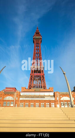 View of blackpool tower from the promenade with town buildings in ...