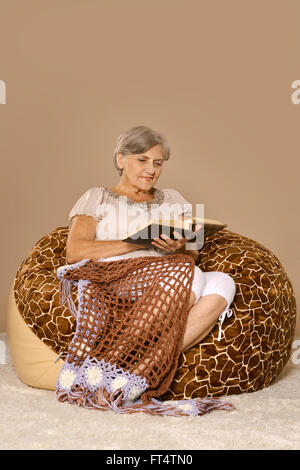 Female senior reading a book - isolated on white background Stock Photo ...