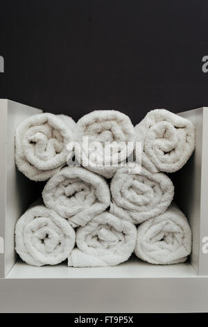 stack of clean towels on simple background Stock Photo - Alamy