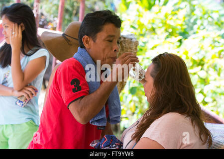 A Mananambal spiritual healer performs a healing ritual on a young ...