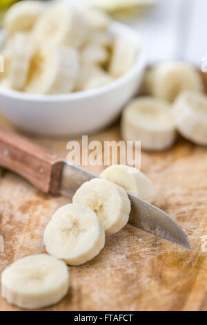 Sliced Bananas (detailed close-up shot) on wooden background Stock ...