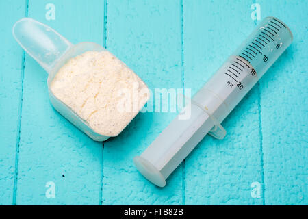 Container of milk whey protein, empty injection and pills. Close-up ...