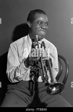 Louis Armstrong - portrait of the American jazz musician holding a ...