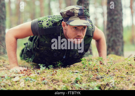 Young army soldier doing push up isolated on white background.Front ...