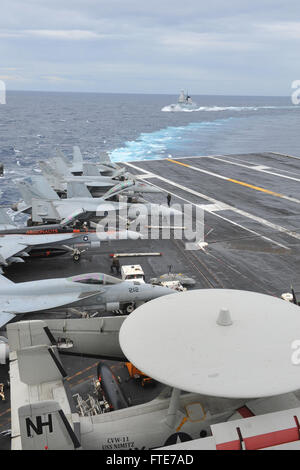 This photo captures the USS Nimitz (CVN 68) transiting the Strait of ...