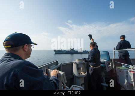 Commanding officer of guided missile destroyer USS Carney sits in the ...