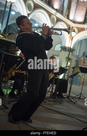 This image captures a Navy Band performing in a Sail Loft, featured in ...