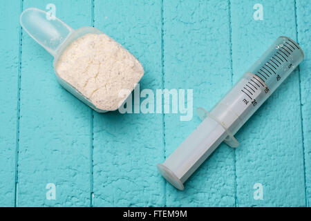 Container of milk whey protein, injection and disc from dumbbell. Close ...