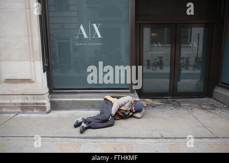 Drug addict man lying in pain at the ground Stock Photo - Alamy