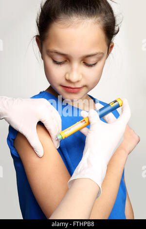 Diabetes, child take insulin. Girl with diabetes during the injections ...