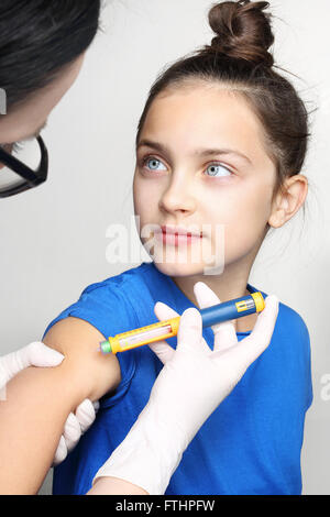 Diabetes, child take insulin. Girl with diabetes during the injections ...