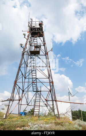 Telecommunication radio tower with transmitters and receivers over cloudy sky Stock Photo - Alamy