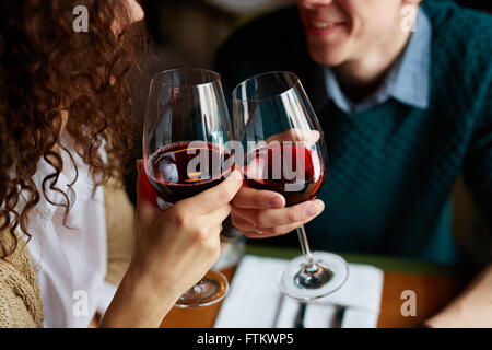 young happy couple toasting red wine glass while having picnic french ...