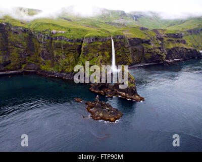 A dramatic waterfall cascades down the north side of Tanaga Island in ...