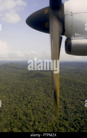 A plane flying over the Amazon rainforest looking down on a meandering ...