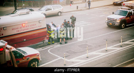 Emergency Medical Workers transfer an obese patient into the ambulance ...