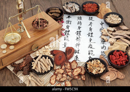 Chinese medicine ingredients with scales and calligraphy on rice paper ...