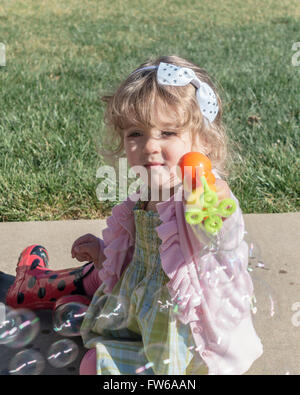 Child making soap bubbles outdoors Stock Photo - Alamy