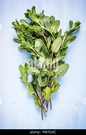 Flat lay of oil, bowl and bouquet of fresh lavender flowers on ...