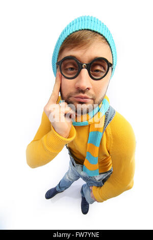 Teen boy in sweater looking away against waving sea and sundown sky in ...
