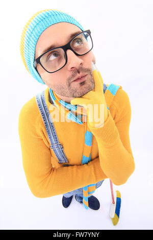 Teen boy in sweater looking away against waving sea and sundown sky in ...