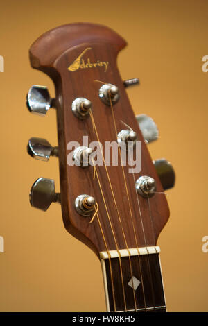 Close up of a guitar head showing the machine heads where the strings ...