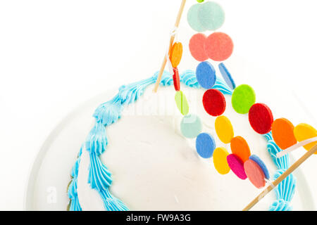 Simple white Birthday cake with cake garland Stock Photo - Alamy