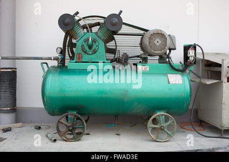 Green air compressor with pressure gauge connected to a compressor via ...