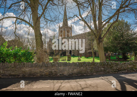 A view of an English country churchyard with headstones, Snowdrops, and ...
