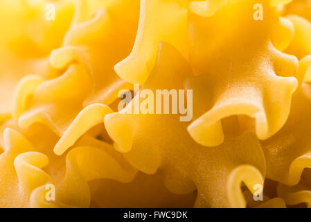 Macro of italian pasta, Mafalda Corta, on a wooden table Stock Photo ...