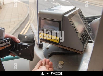 Passenger paying the fare on a First bus in Sheffield South Yorkshire ...