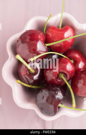 Cherries in a pink bowl Stock Photo - Alamy
