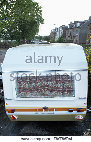 An old, run-down caravan has been parked on a lawn for the rest of ...