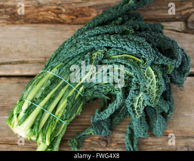 A delicious vegetables, the Kale or leaf cabbage on an old wooden table ...