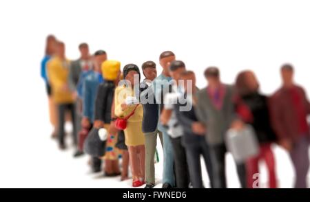 Miniature figure people forming an orderly queue against a white ...