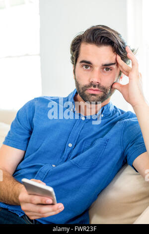 Tensed young man with head in hands Stock Photo - Alamy