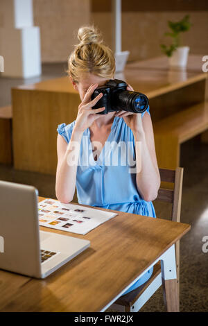 Woman clicking photo from camera Stock Photo - Alamy