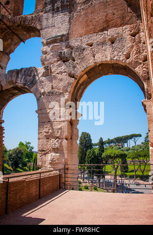 View of the ancient ruins of the Colosseum through pillars of the ...
