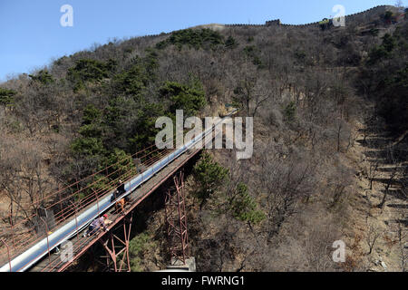 Mutianyu, China - Tourist sliding down the Toboggan slide at the Great ...