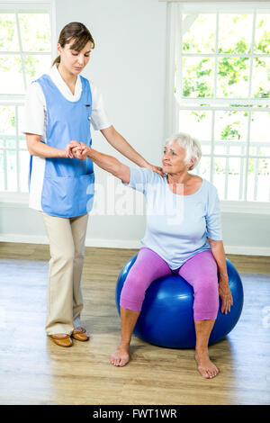 Senior woman exercising with nurse Stock Photo - Alamy