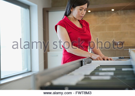 Serious businesswoman searching files Stock Photo - Alamy