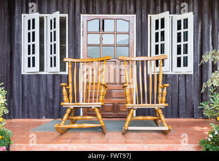 Rocking chair in front of window with old oar used as curtain rod for ...