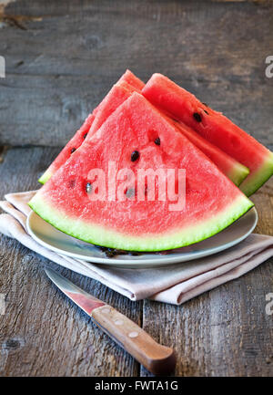 Plate with slices of watermelon and knife on white background Stock ...