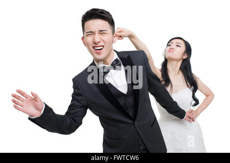 Bride pulling groom's ear Stock Photo - Alamy