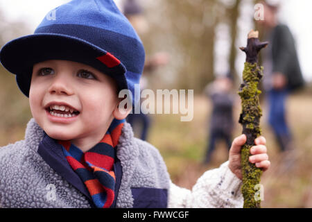 Boy holding stick Stock Photo - Alamy