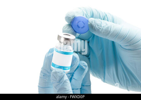 Nurse removes cap from syringe to prepare it for use Stock Photo - Alamy