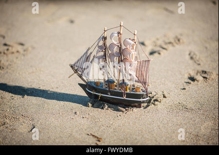 Sail Ship Toy Model in the Beach Sand Close-up Stock Photo - Alamy
